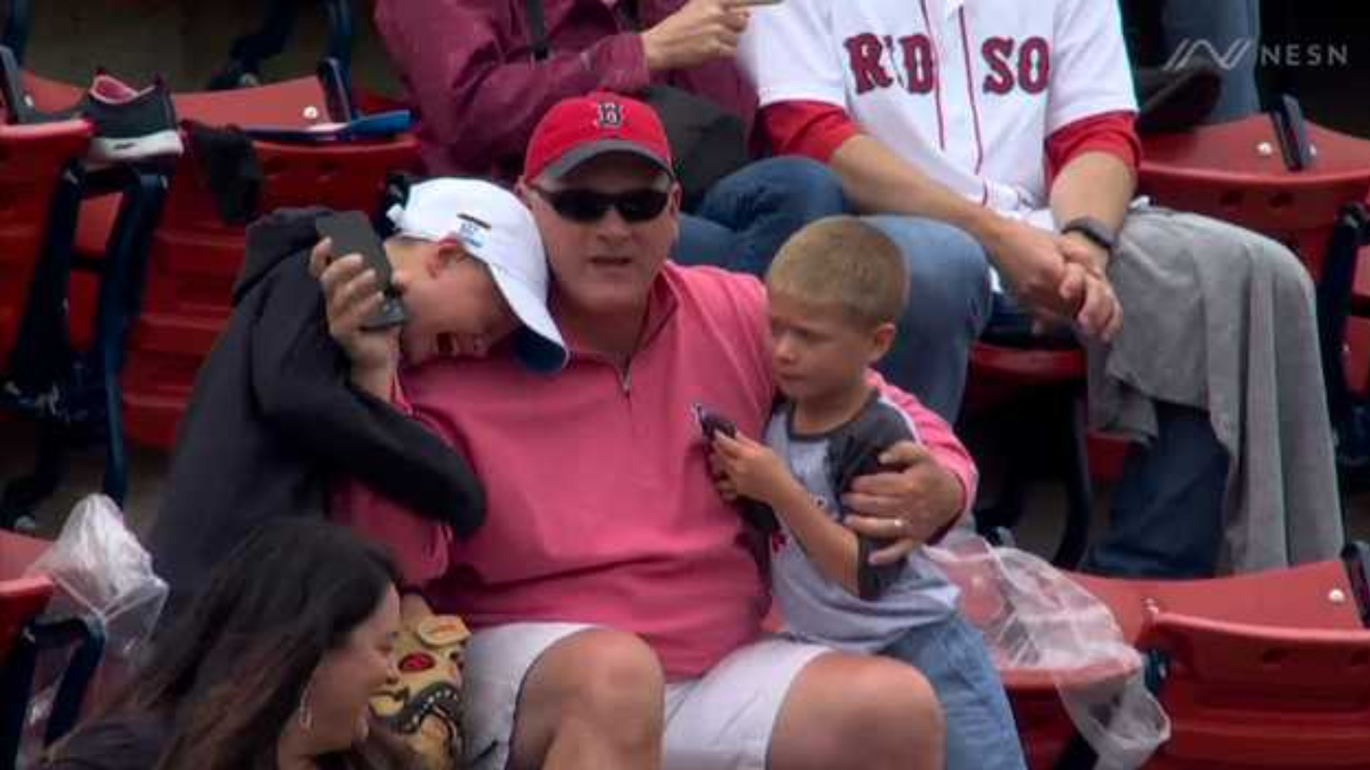 Dad has his hands full during a Red Sox game for the wrong reasons ...